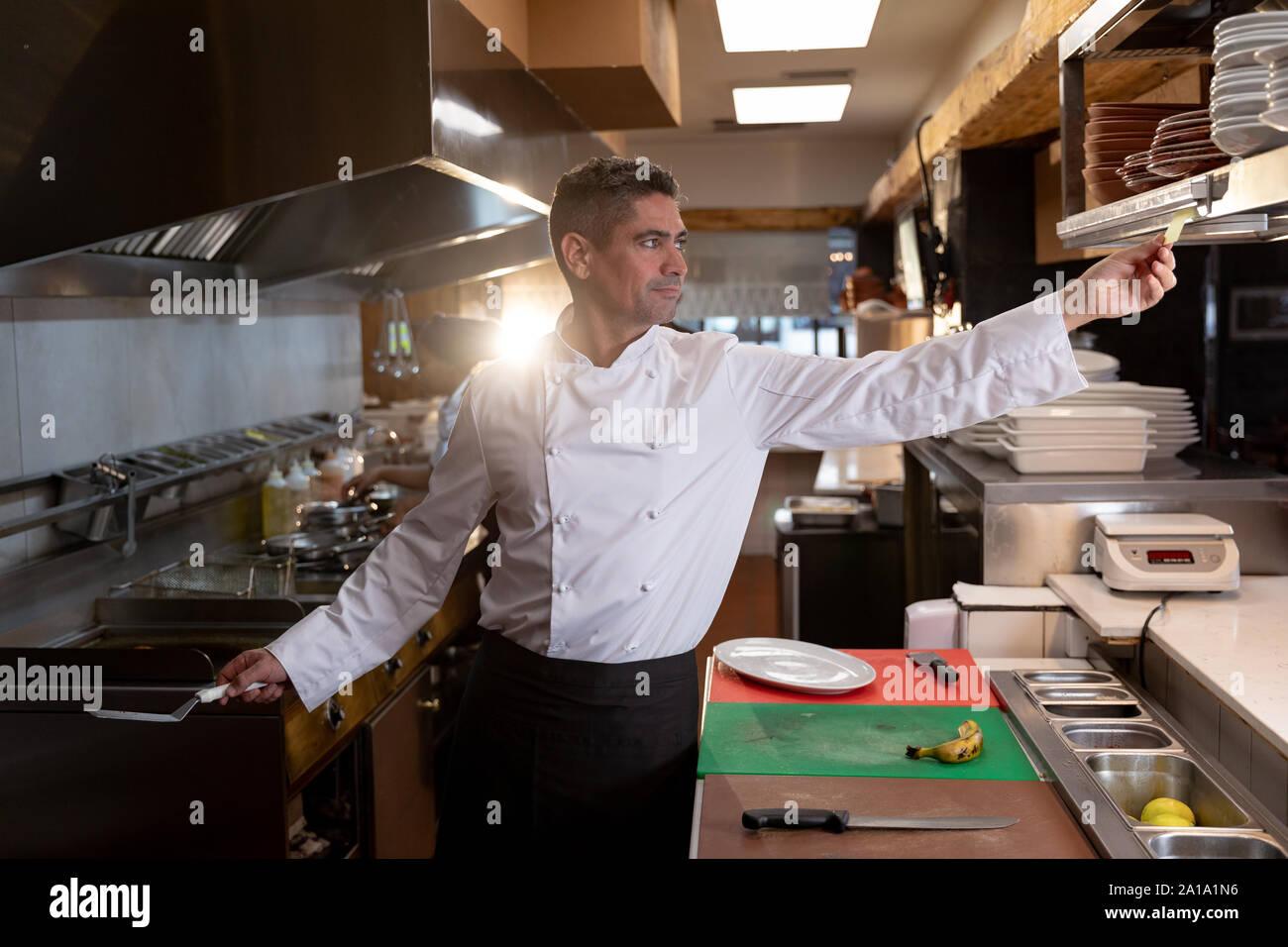 Chef checking orders in restaurant Stock Photo - Alamy
