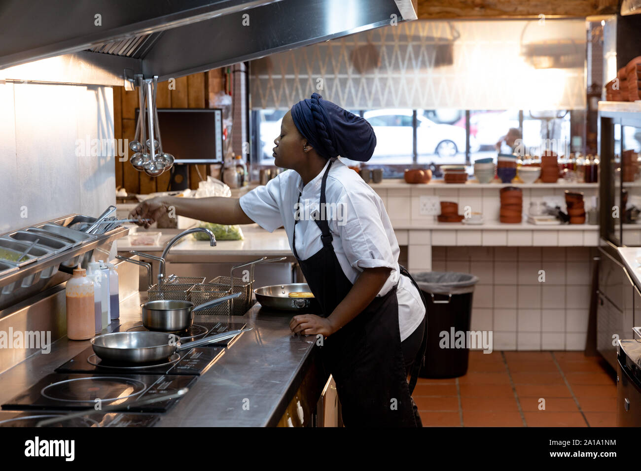 Woman working in restaurant kitchen Stock Photo - Alamy