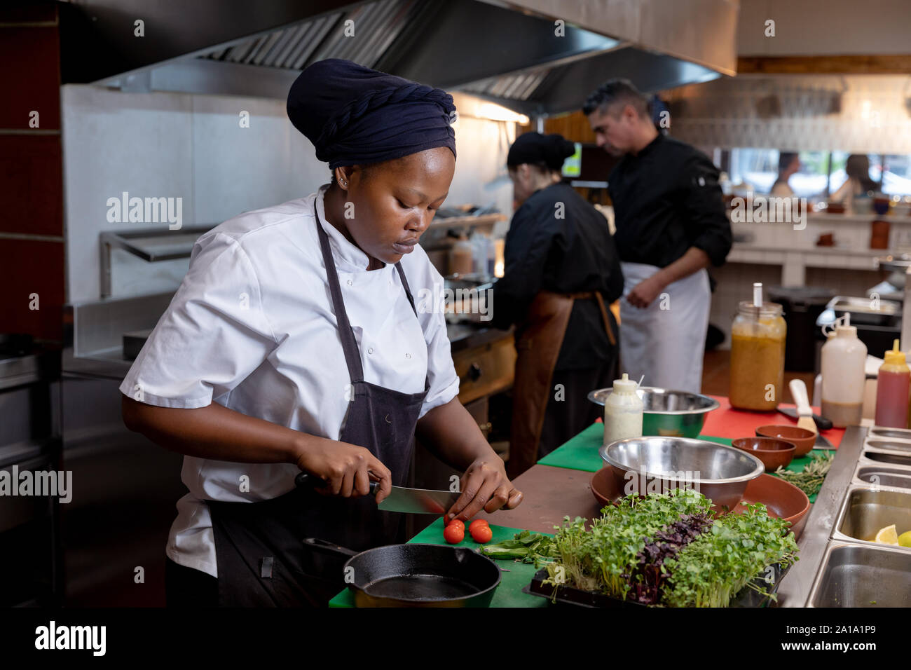 Chefs working in busy restaurant kitchen Stock Photo - Alamy