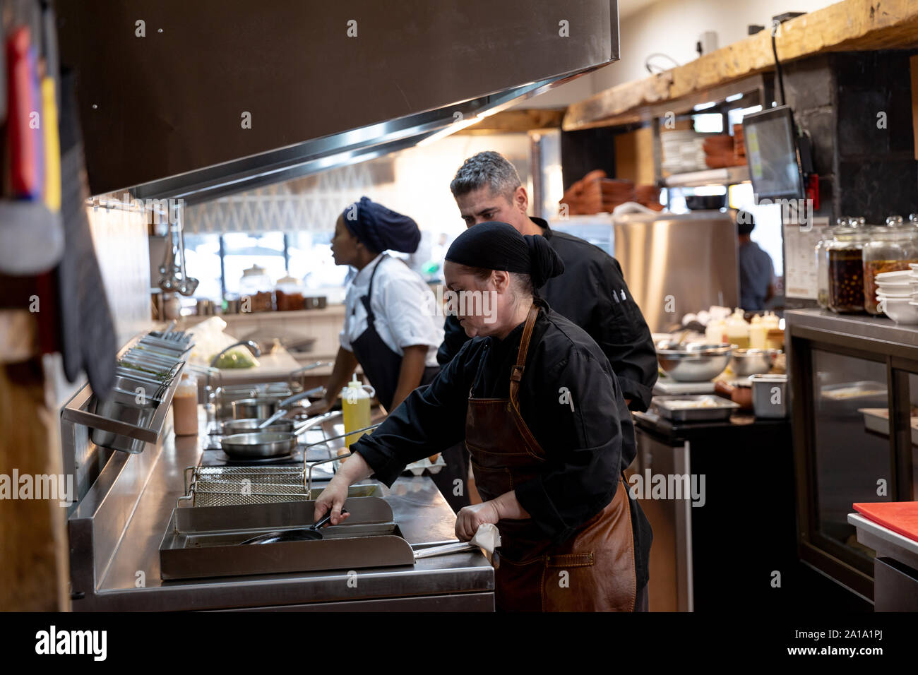 Chefs working in busy restaurant kitchen Stock Photo - Alamy