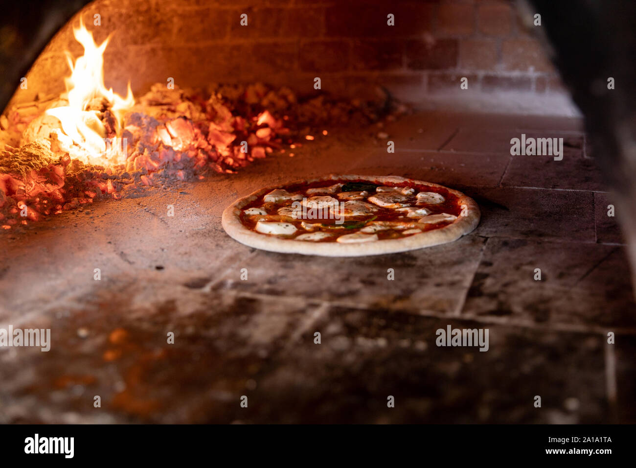 Pizza cooking in pizza oven Stock Photo - Alamy