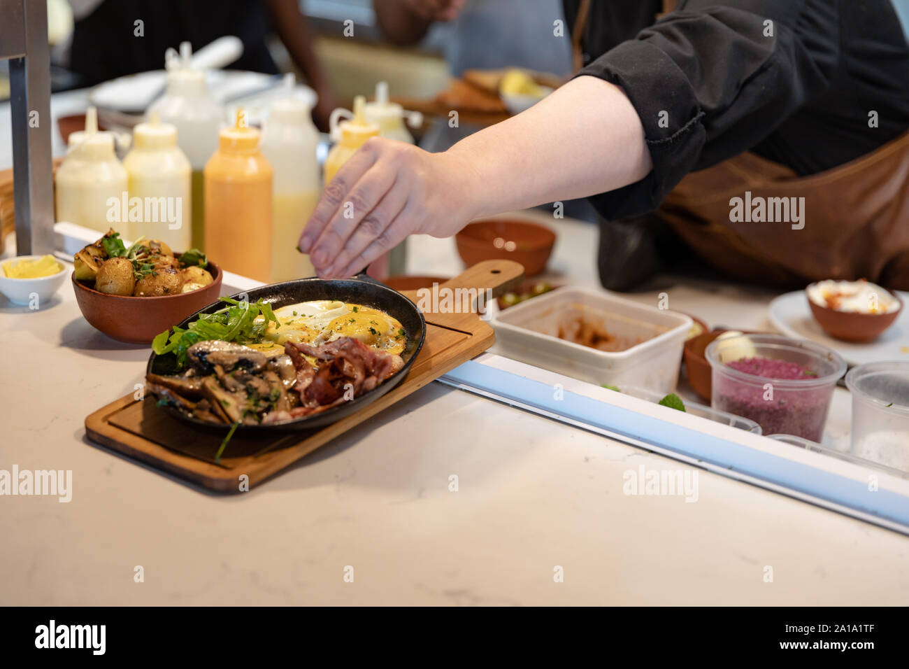 Woman frying bacon hi-res stock photography and images - Alamy