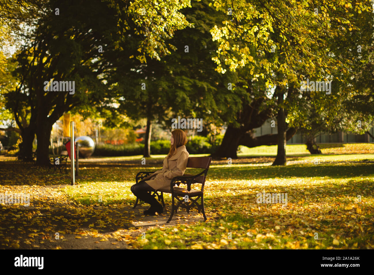 Woman sitting on bench showing hi-res stock photography and images - Alamy
