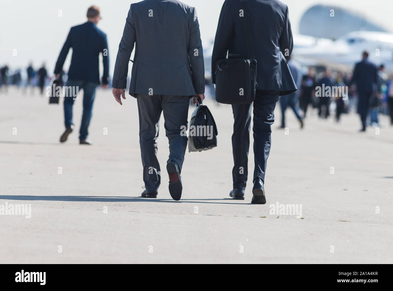 Business people walking down the street talking. Back view Stock Photo ...