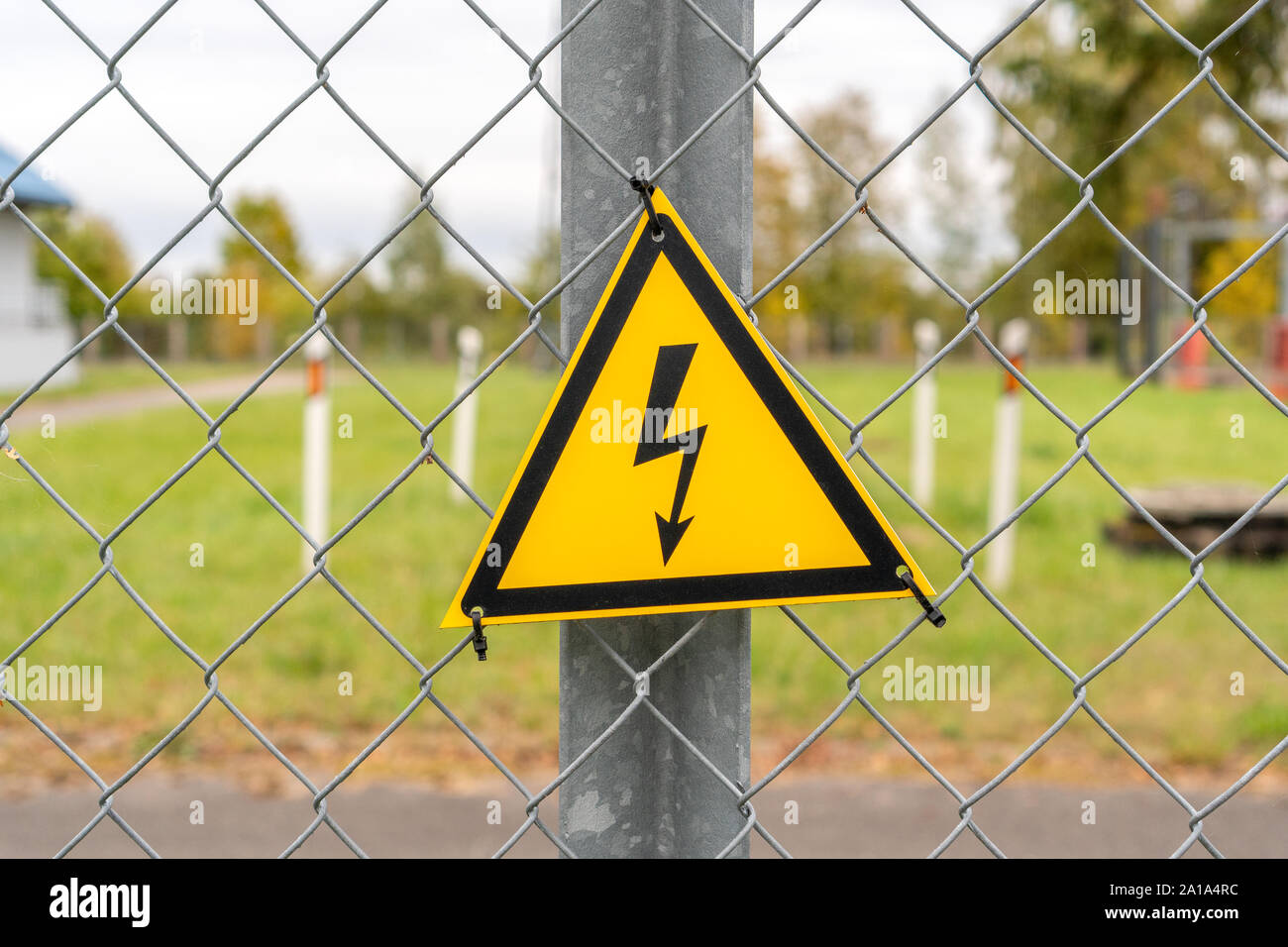 Warning sign on boundary fence of electricity substation Stock Photo ...