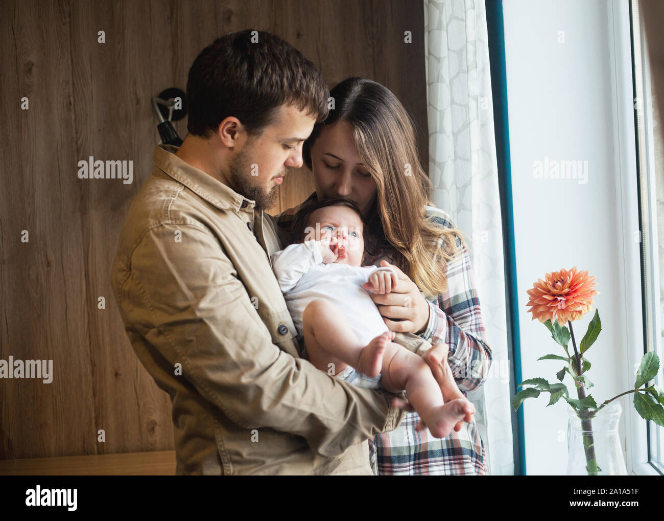 Lovely family of young parents and baby at home. Family, childhood and ...
