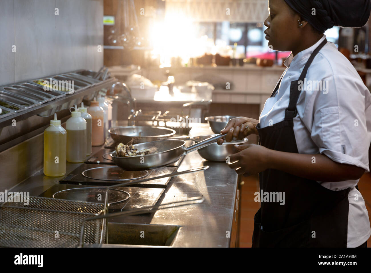 Woman frying in restaurant kitchen Stock Photo - Alamy
