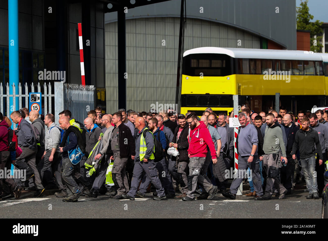 Workers walk through the gates of the Wrightbus plant in Ballymena ...