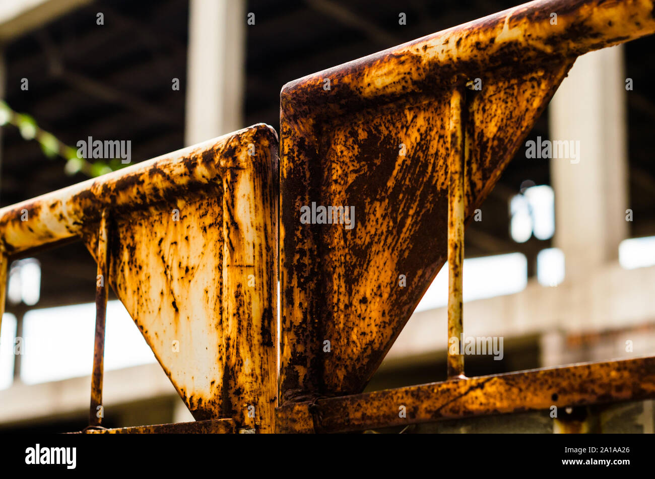 rusty fence with a view of an abandoned concrete building Stock Photo ...