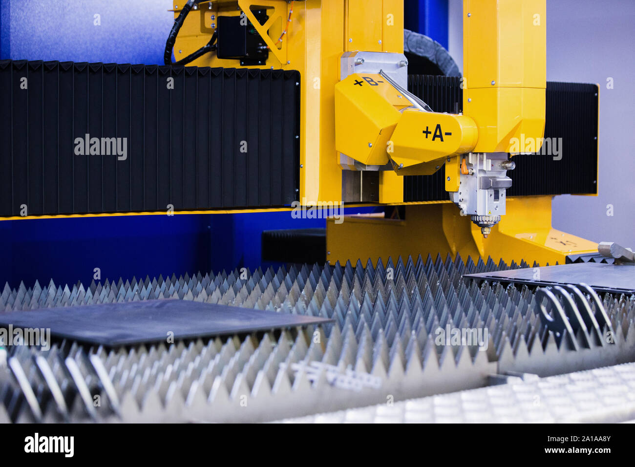 Automatic machine with robotic arm for cutting metal. Smart factory ...