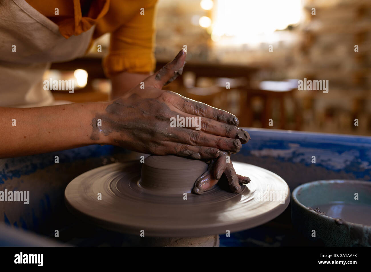 Hands of female potter in a pottery studio using pottery wheel Stock ...