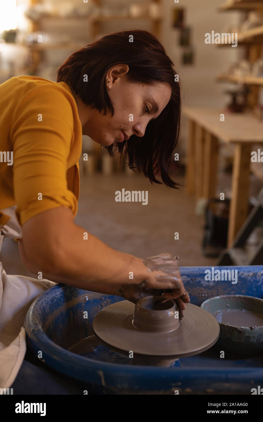 Female potter in a pottery studio using pottery wheel Stock Photo - Alamy