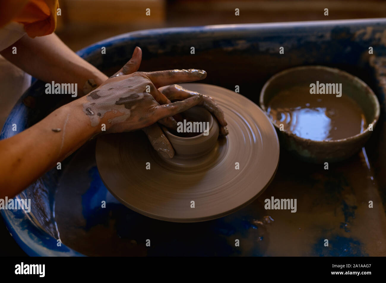 Hands of female potter in a pottery studio using pottery wheel Stock ...
