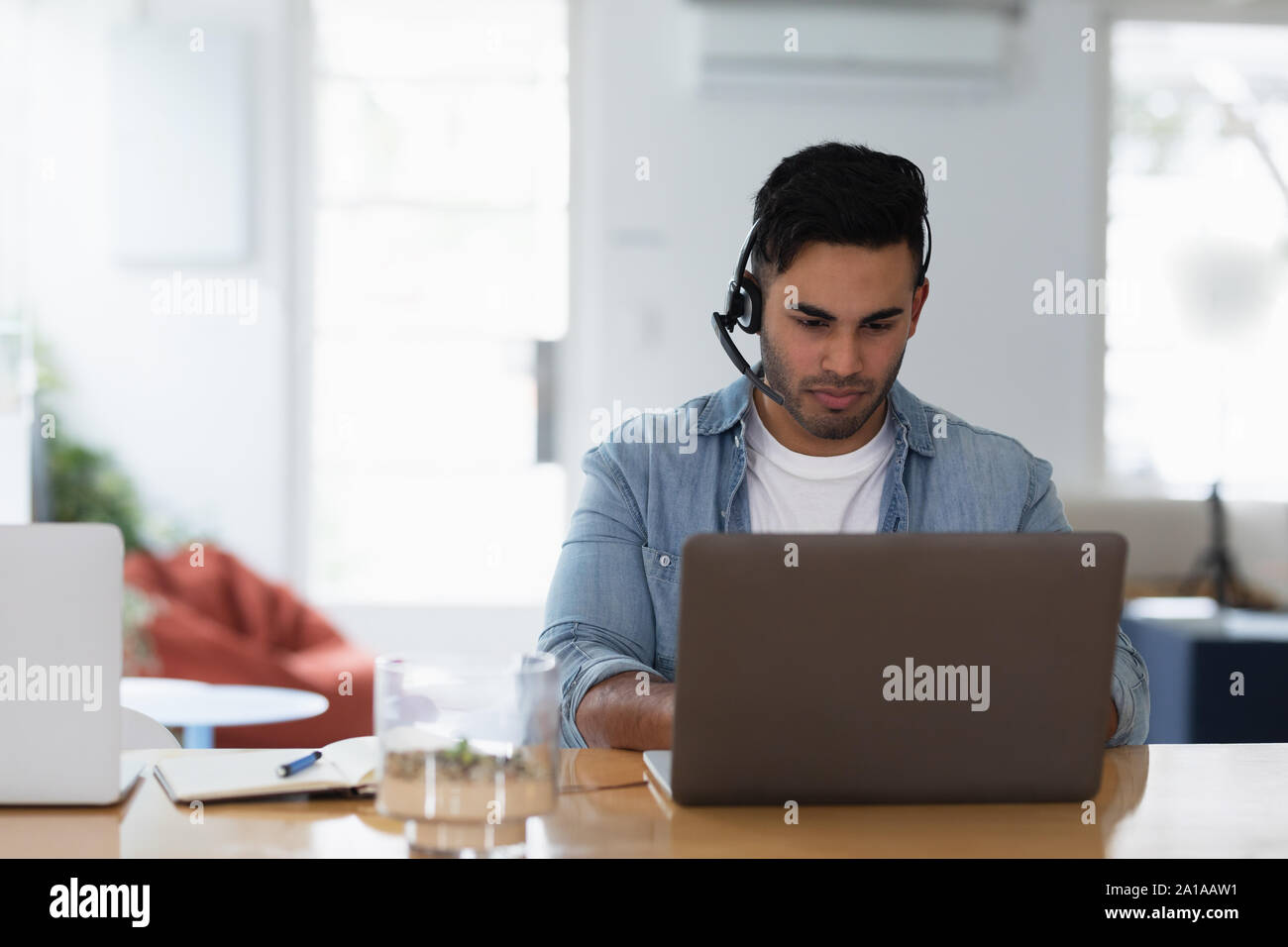 Young male creative in an office Stock Photo - Alamy