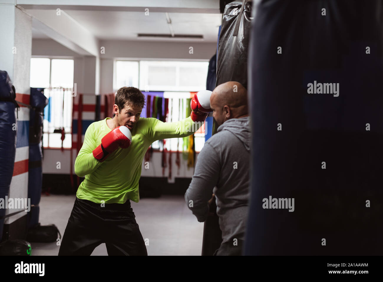 Male boxer training with a couch in a boxing gym Stock Photo - Alamy