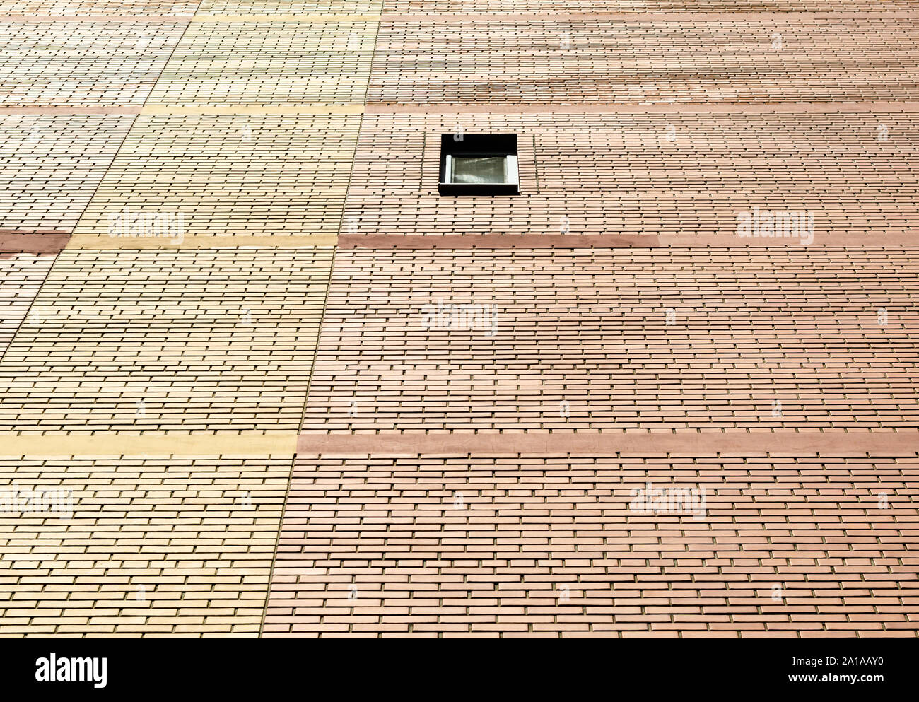 high brick wall with a single window Stock Photo - Alamy