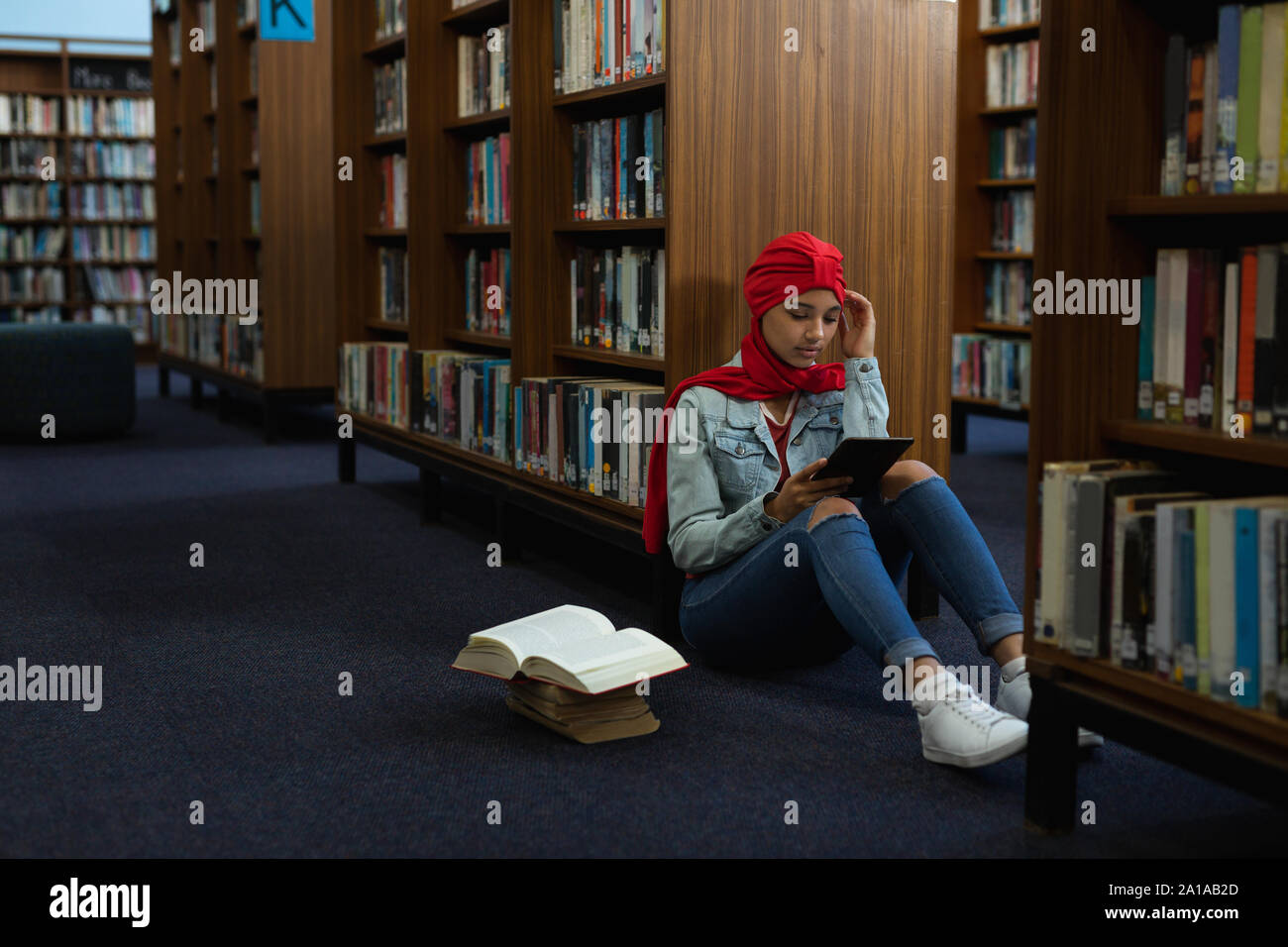Young woman studying in library Stock Photo - Alamy