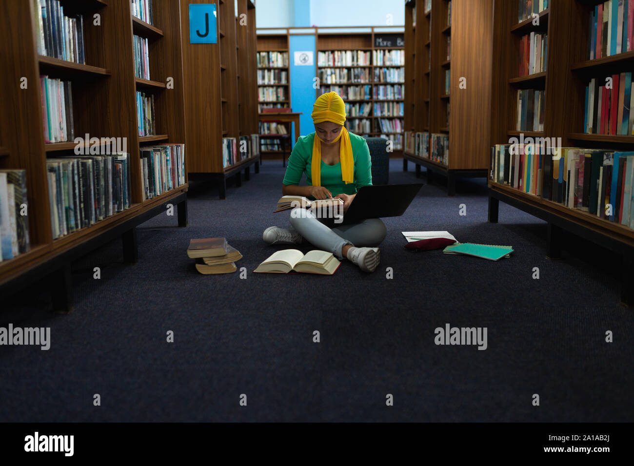 Young woman studying in library Stock Photo - Alamy