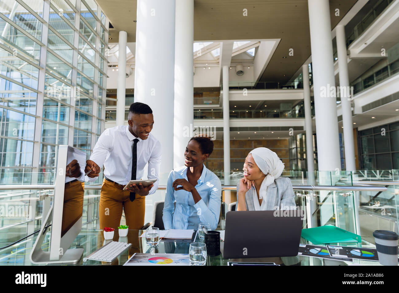 Executives discussing over digital laptop hi-res stock photography and ...