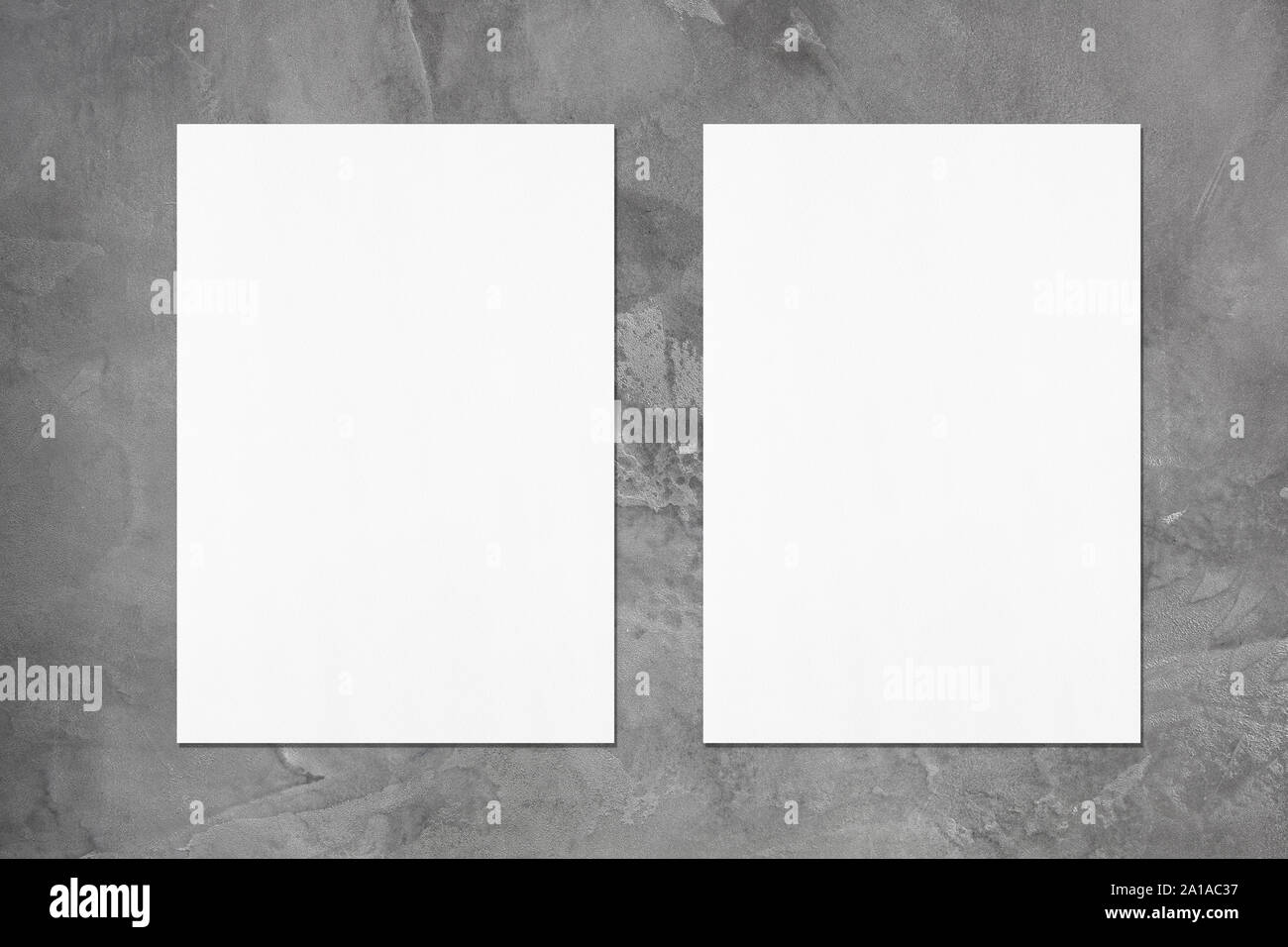 Two empty white vertical rectangle poster mockups with soft shadows on ...