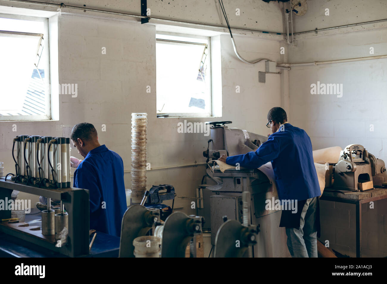 Two men working in a sports equipment factory Stock Photo - Alamy