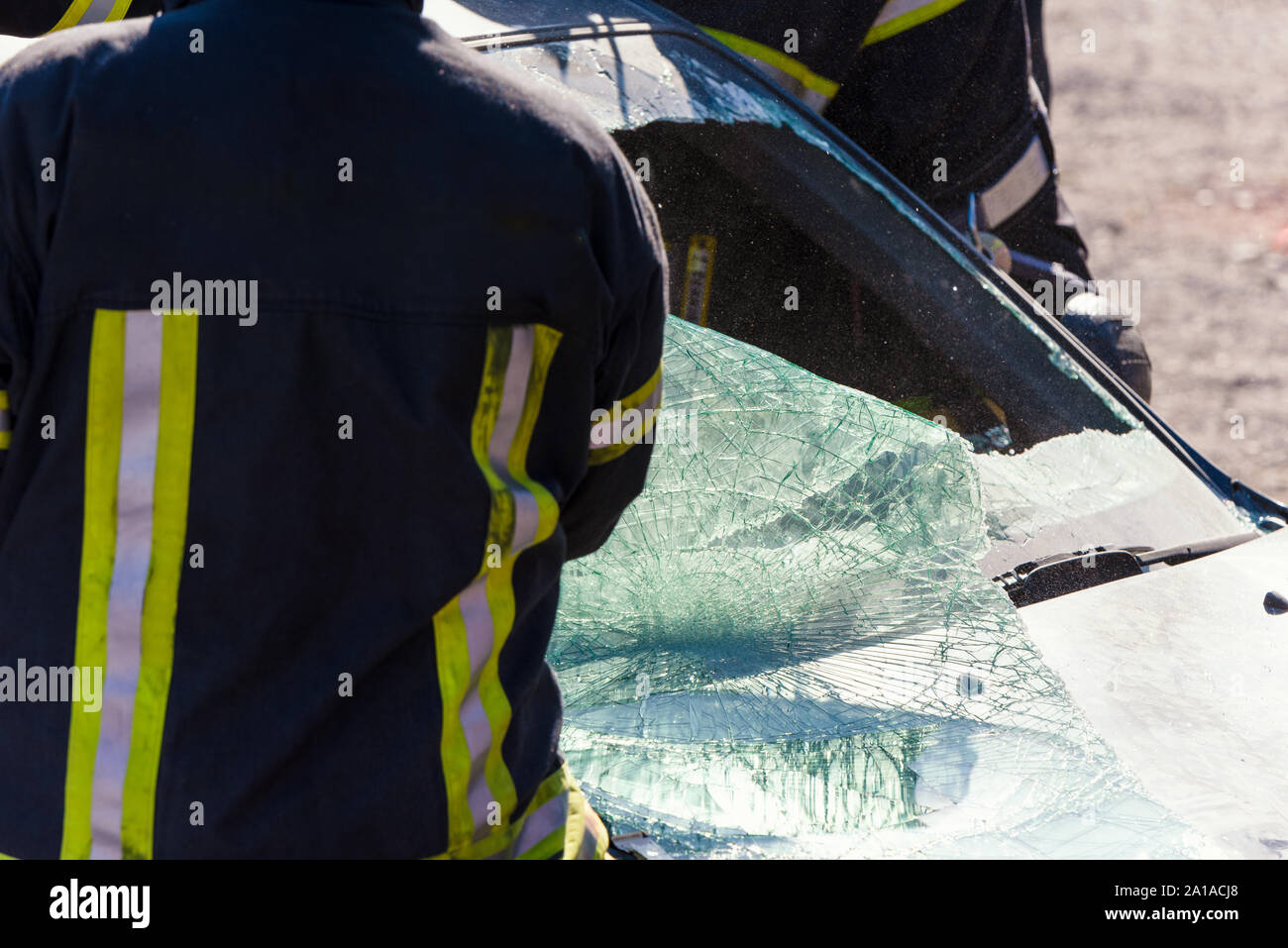 Firefighters, fireman cut a car glass in car accident Stock Photo - Alamy