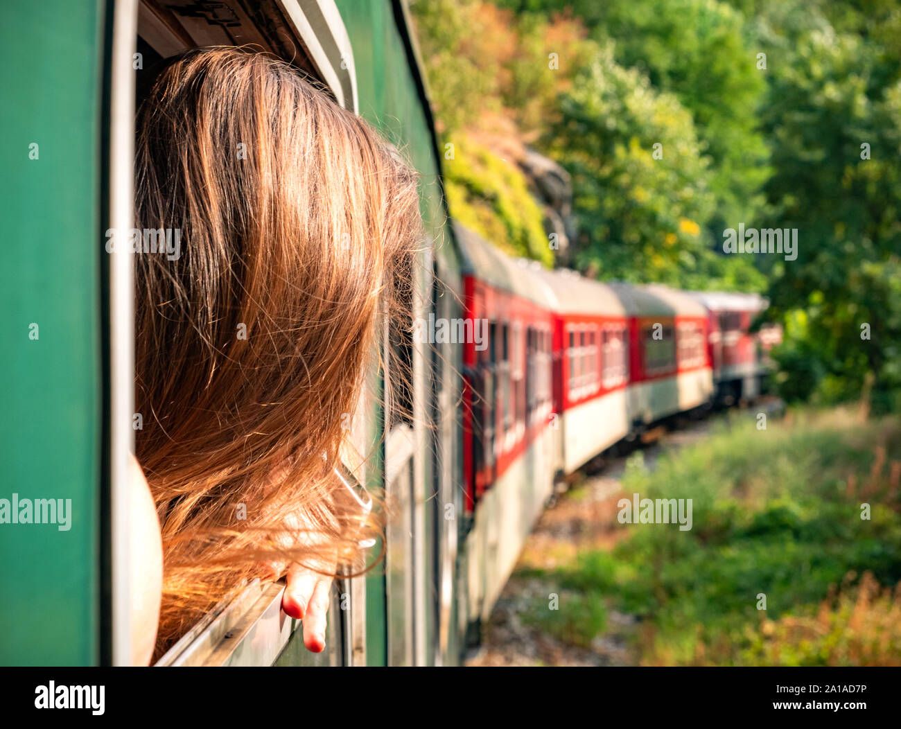 Woman looking out the window of the old train. Bulgarian mountains ...