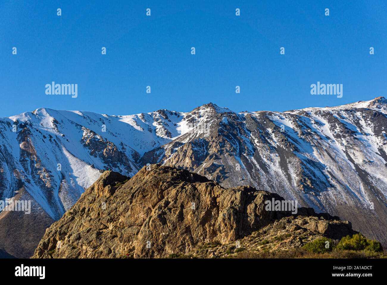 Scene view of mountain climbers reaching mountain peak against snow ...