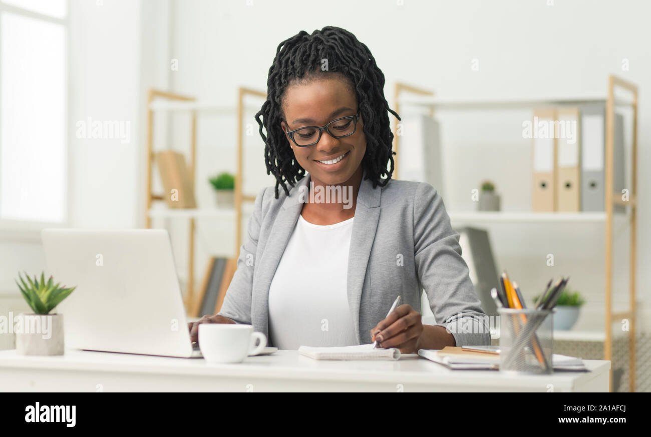 Black Office Girl Sitting At Laptop Taking Notes At Work Stock Photo ...