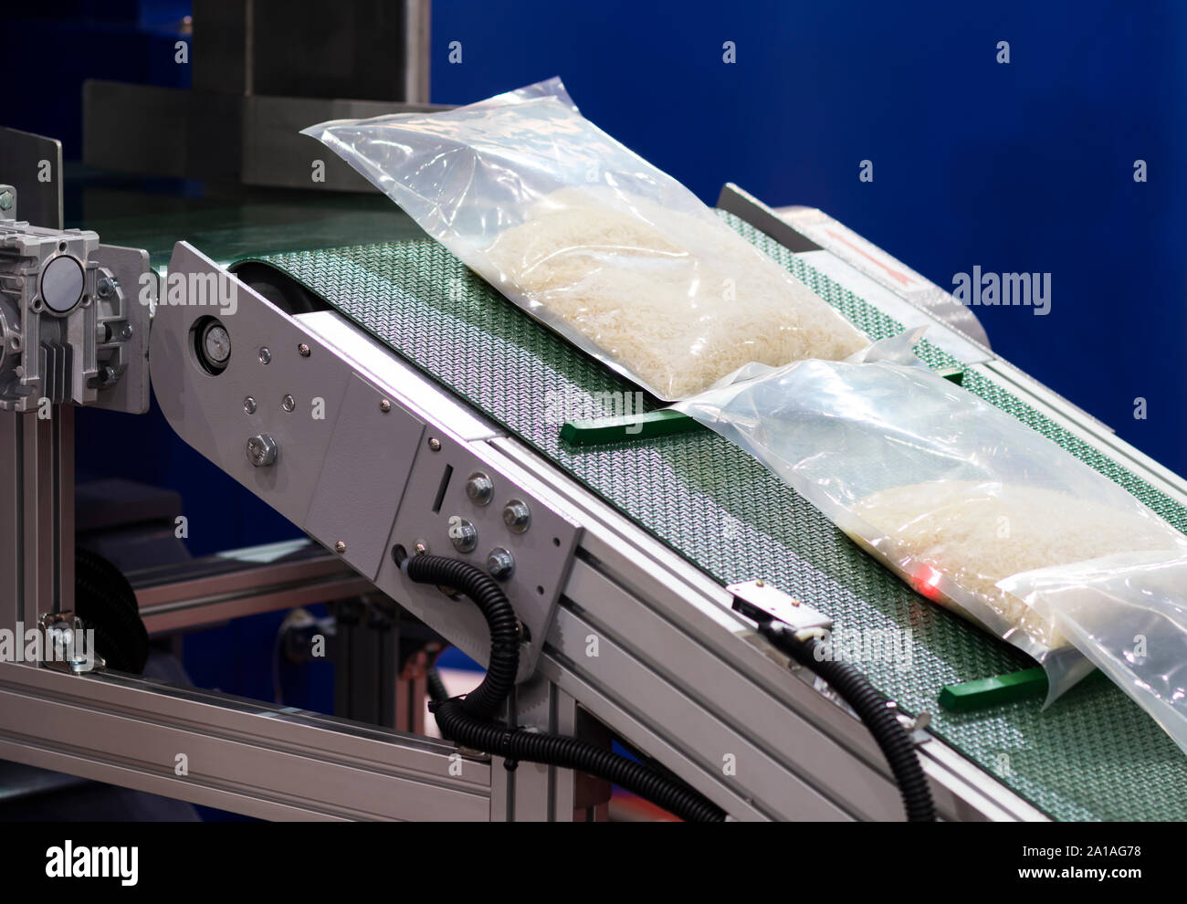rice packing in plastic bag on conveyor line ; close up Stock Photo - Alamy