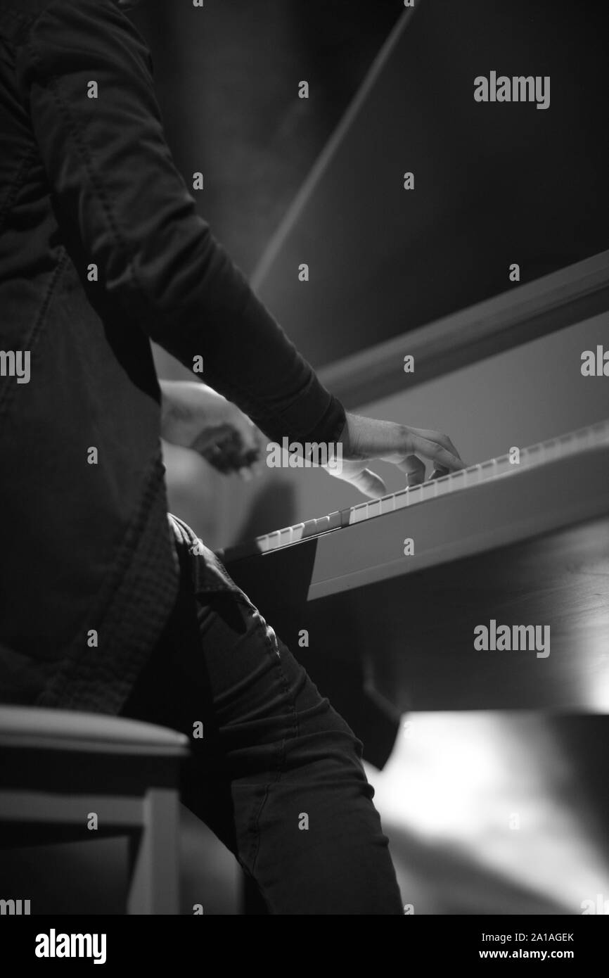 The pianist performs a musical work on the piano on stage Stock Photo ...