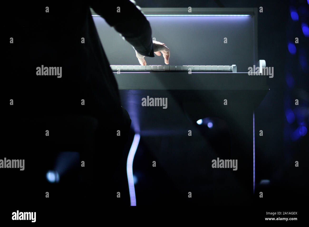 The pianist performs a musical work on the piano on stage Stock Photo ...