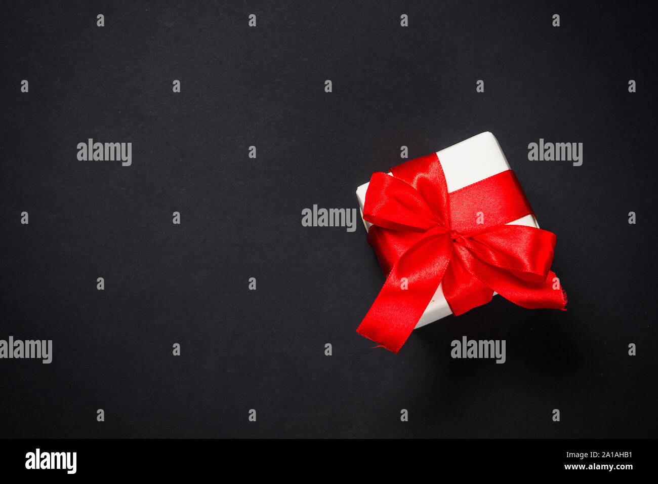 Present box on black background Stock Photo - Alamy
