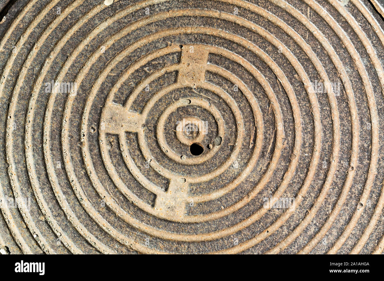 beige concentric round texture cast-iron hatch cover of brown rusty ...