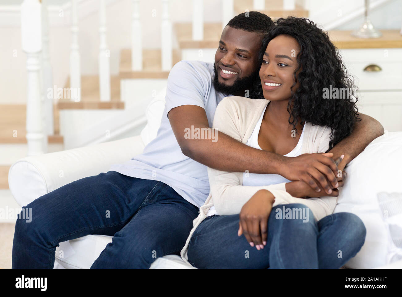 Black couple sitting on couch at home, watching tv together Stock Photo ...