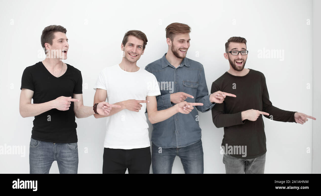 cheerful group of friends showing their fingers to the side Stock Photo ...