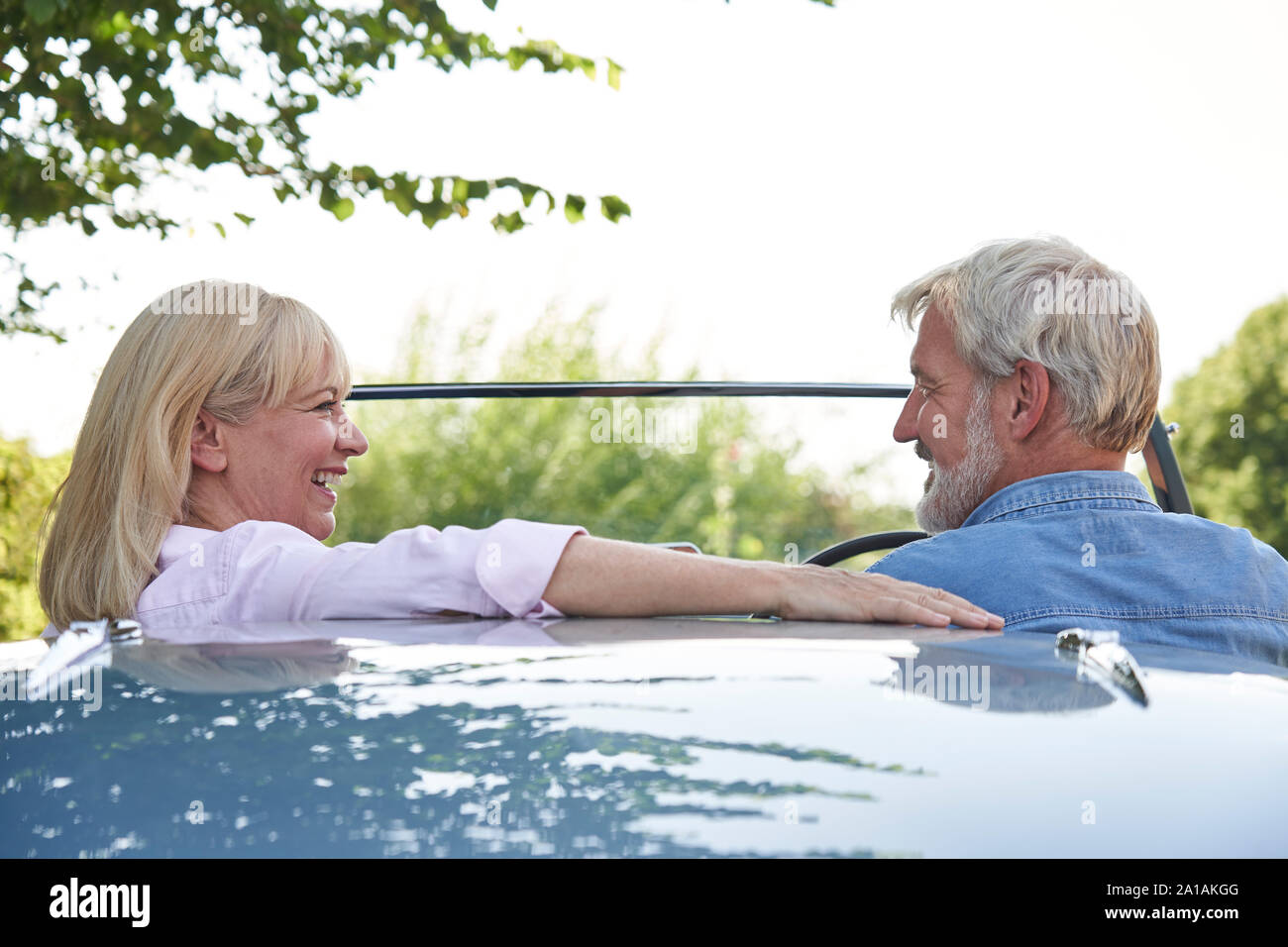 Rear View Of Mature Couple Enjoying Road Trip In Classic Open Top ...