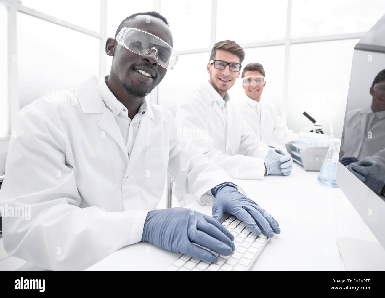 group of scientists sitting at the laboratory table Stock Photo - Alamy