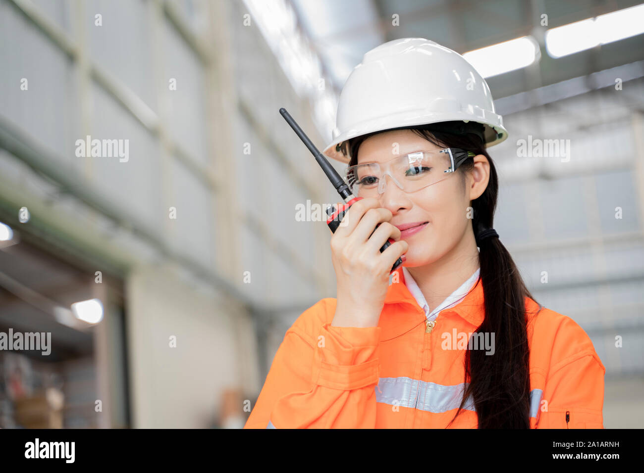 Engineer asian women using radio communication in factory Stock Photo ...