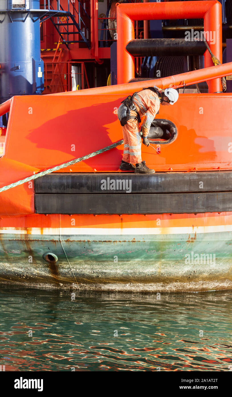 Man, worker, workman painting ship Stock Photo - Alamy