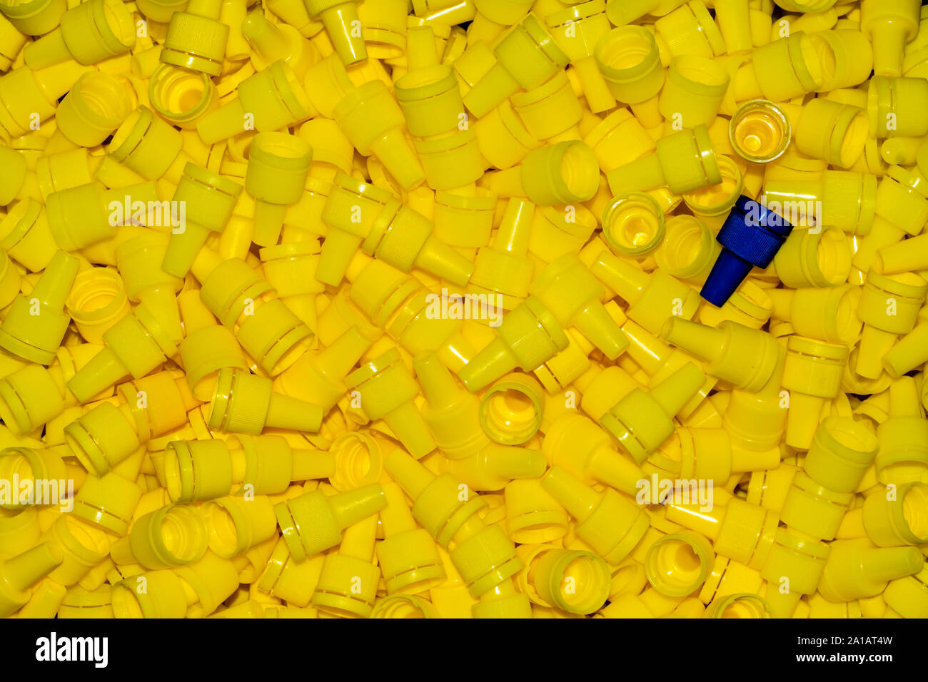 texture yellow plastic caps with one blue lid Stock Photo - Alamy