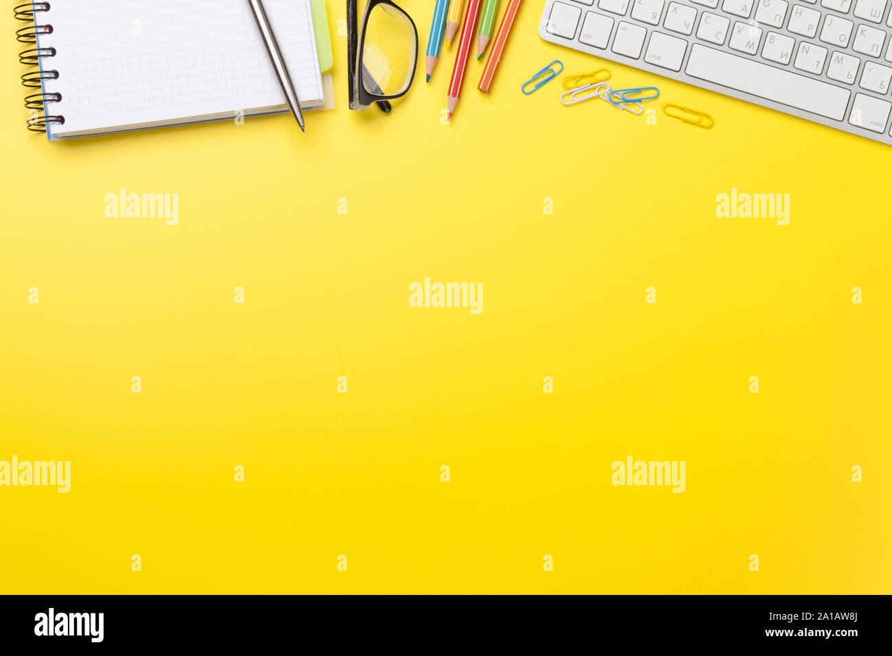 Office yellow workplace backdrop with supplies and computer. Flat lay ...