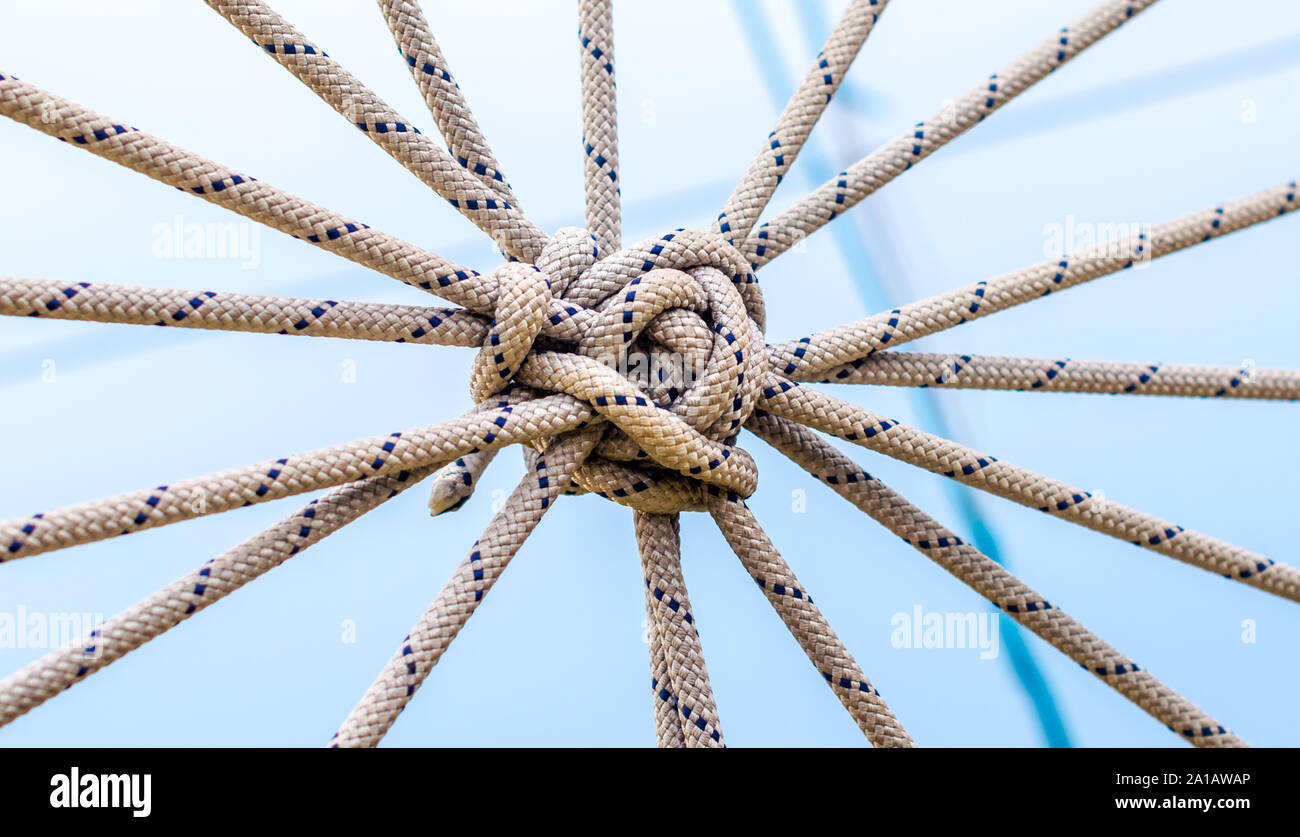 lots of ropes and a big knot against the blue sky Stock Photo - Alamy