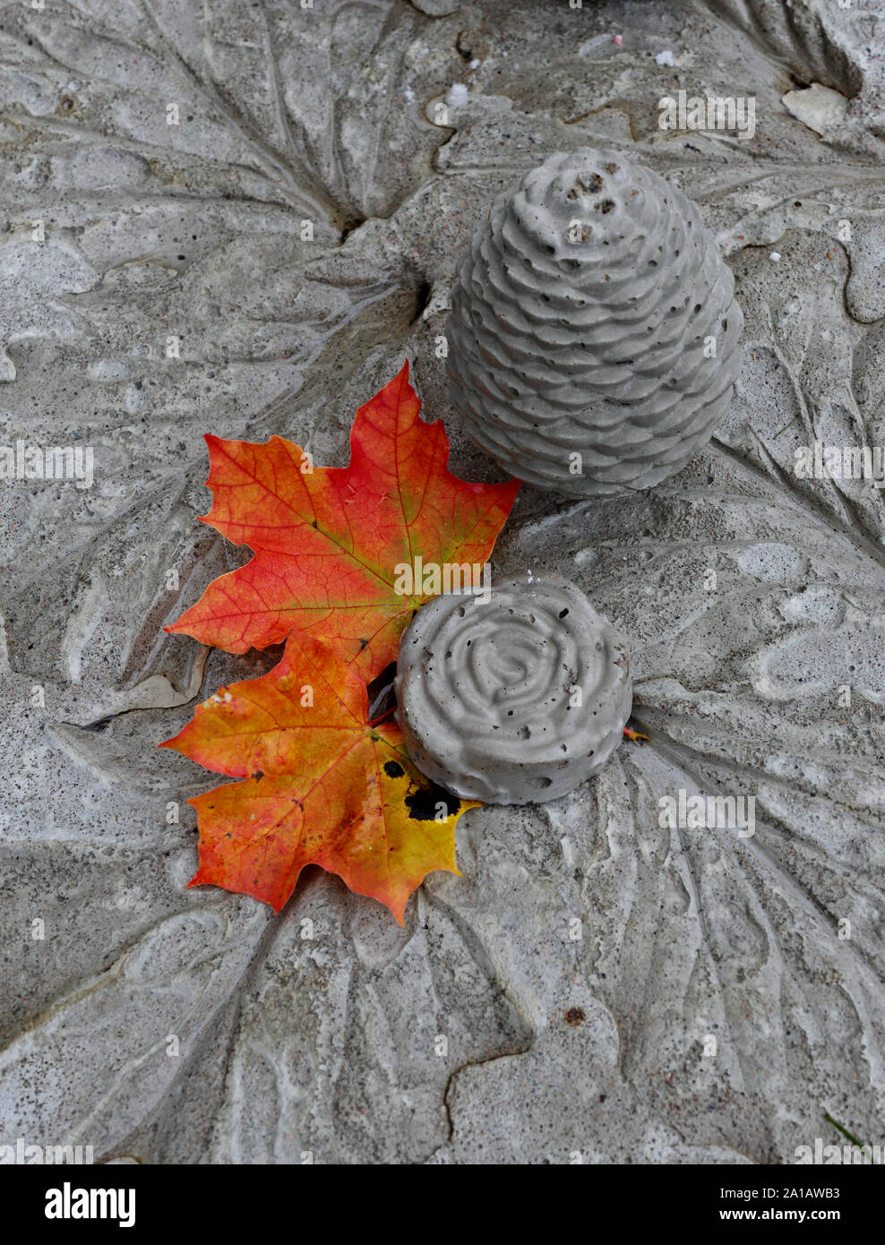 An arrangement of red maple leaves, a grey rose and a cone hand made of ...