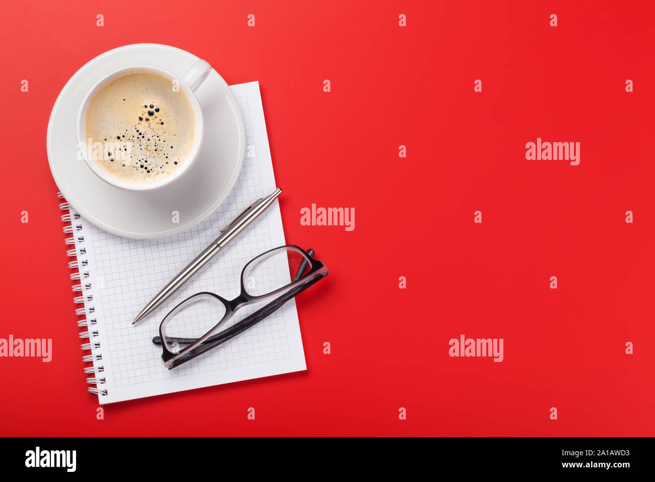 Office red workplace backdrop with coffee cup and supplies. Flat lay ...
