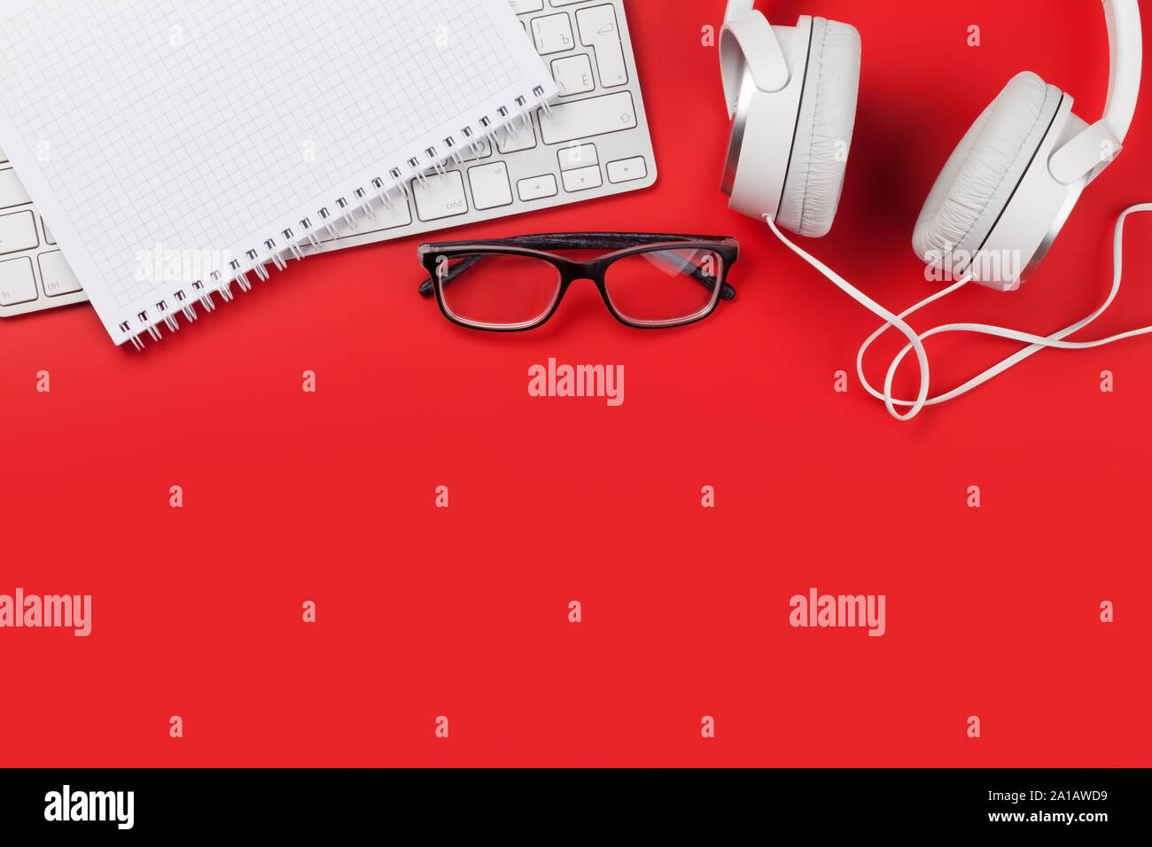 Office red workplace backdrop with headphones, supplies and computer ...