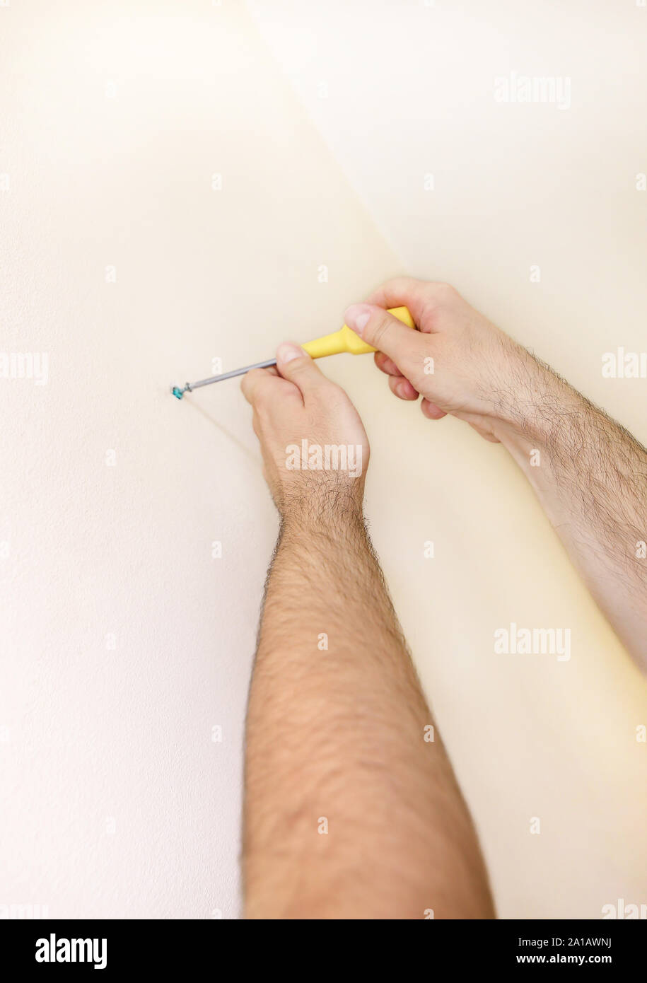 Construction worker and handyman works on renovation of apartment ...