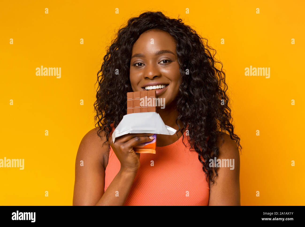 Beautiful african woman holding chocolate hi-res stock photography and ...