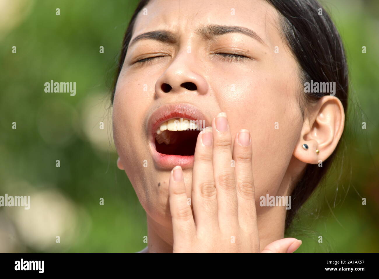 A Young Diverse Female With Toothache Stock Photo - Alamy