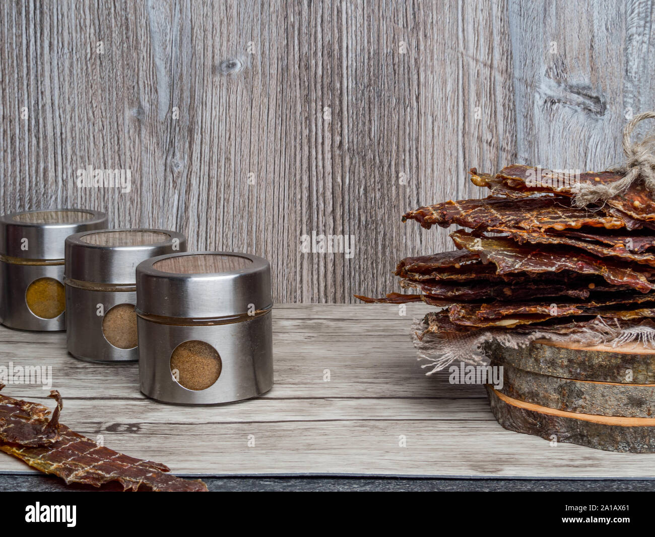 Dried or dehydrated meat slices with spices in jars, copy space Stock ...